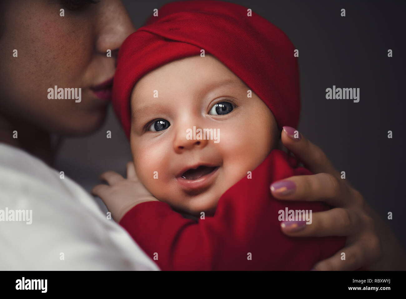 Loving Mother Cuddling Newborn Baby daughter Over Shoulder Stock Photo ...