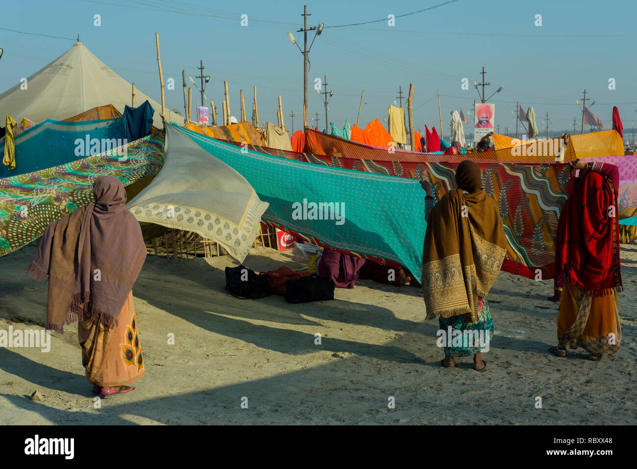 Women dry saree after taking a bath at Kumbh mela Stock Photo - Alamy