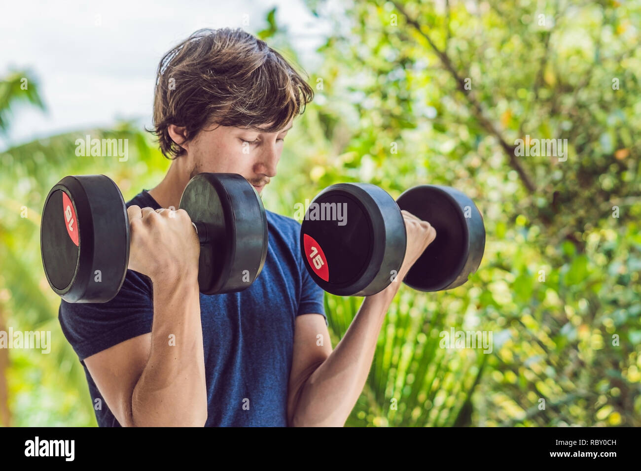 Bicep curl - weight training fitness man outside working out arms ...