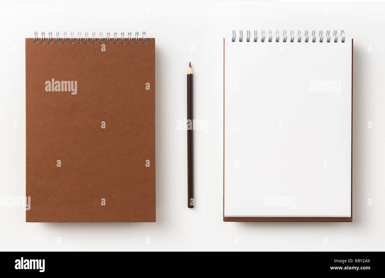 Design concept - Top view of brown spiral notebook, white page and ...