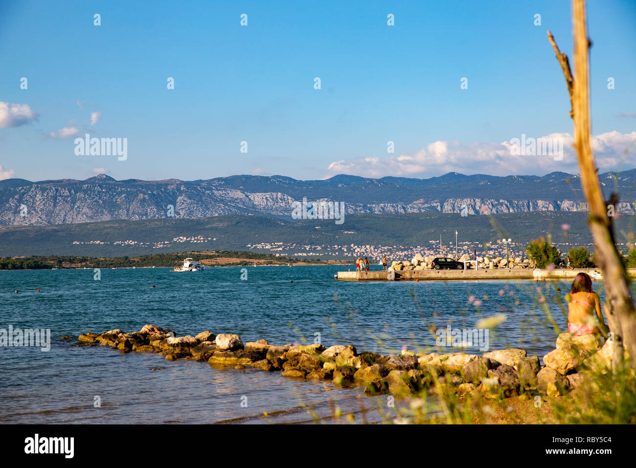 Beach overlooking Soline Bay with the Dinaric Alps in the background as ...