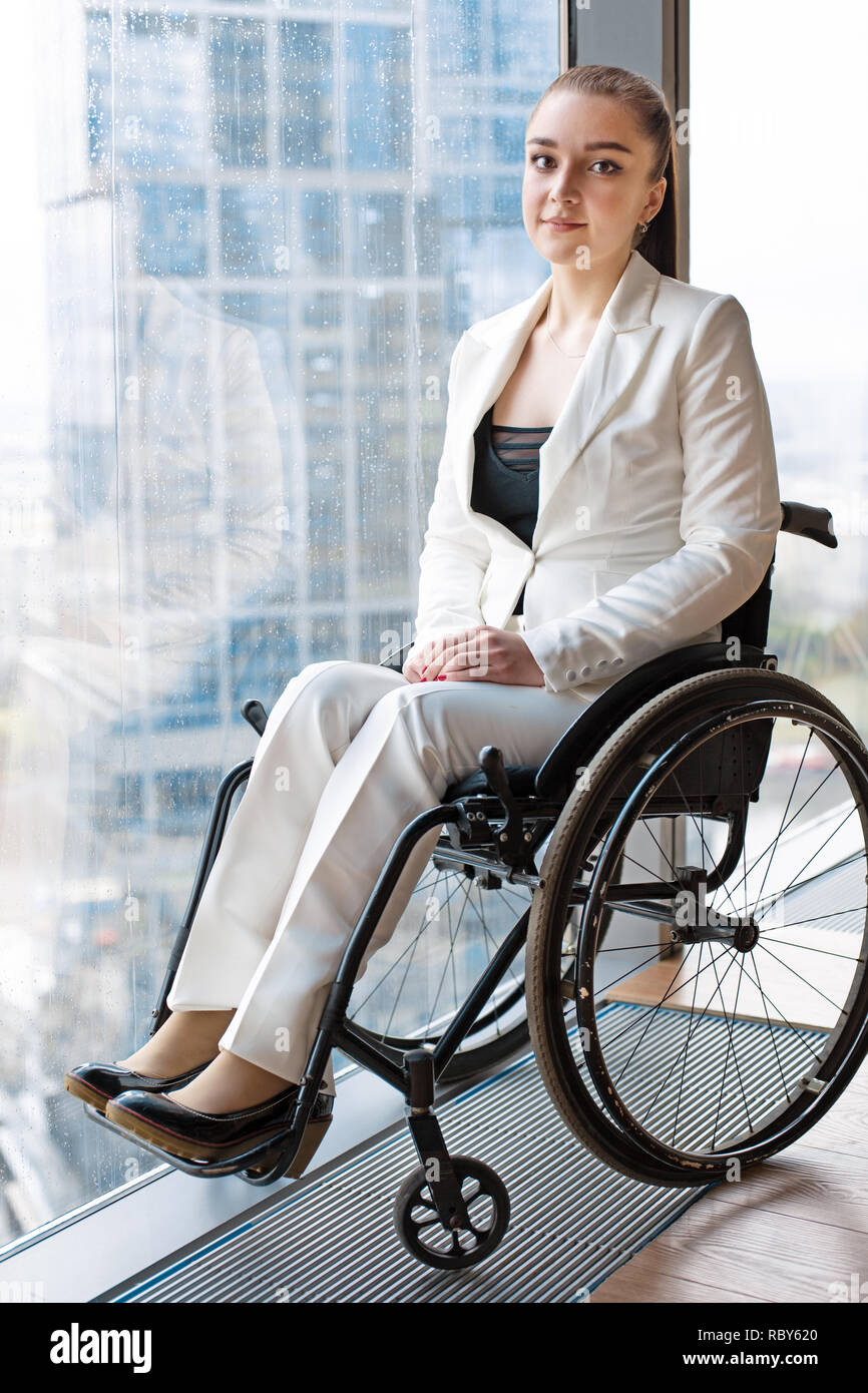 Confident happy businesswoman in wheelchair against the background of a ...