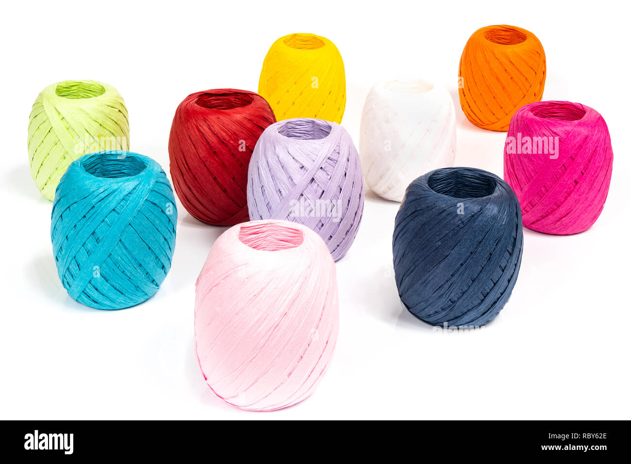 some balls of colored raffia on a white surface Stock Photo - Alamy