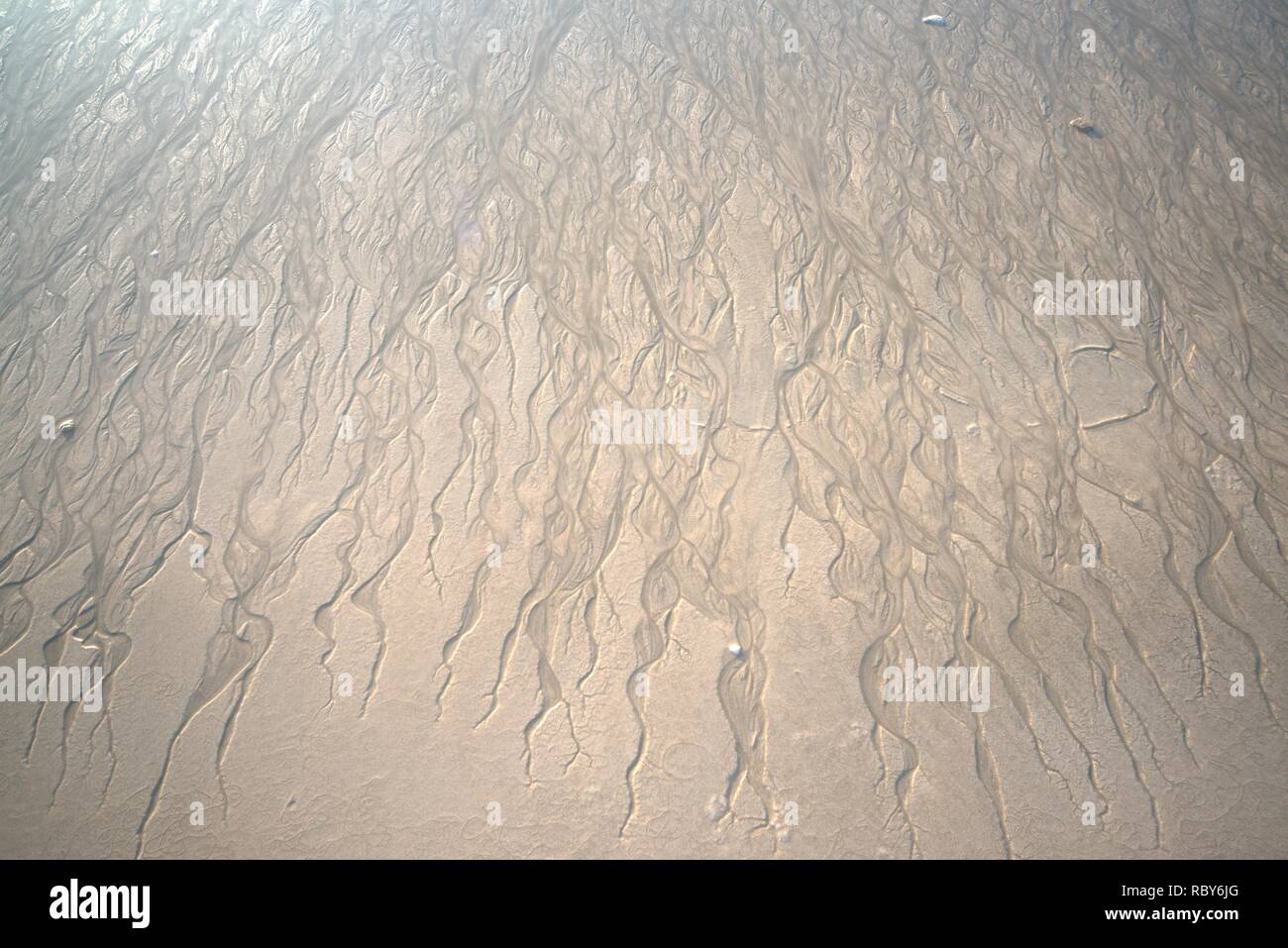 Sand rippled textured pattern and background created by low tide on a ...