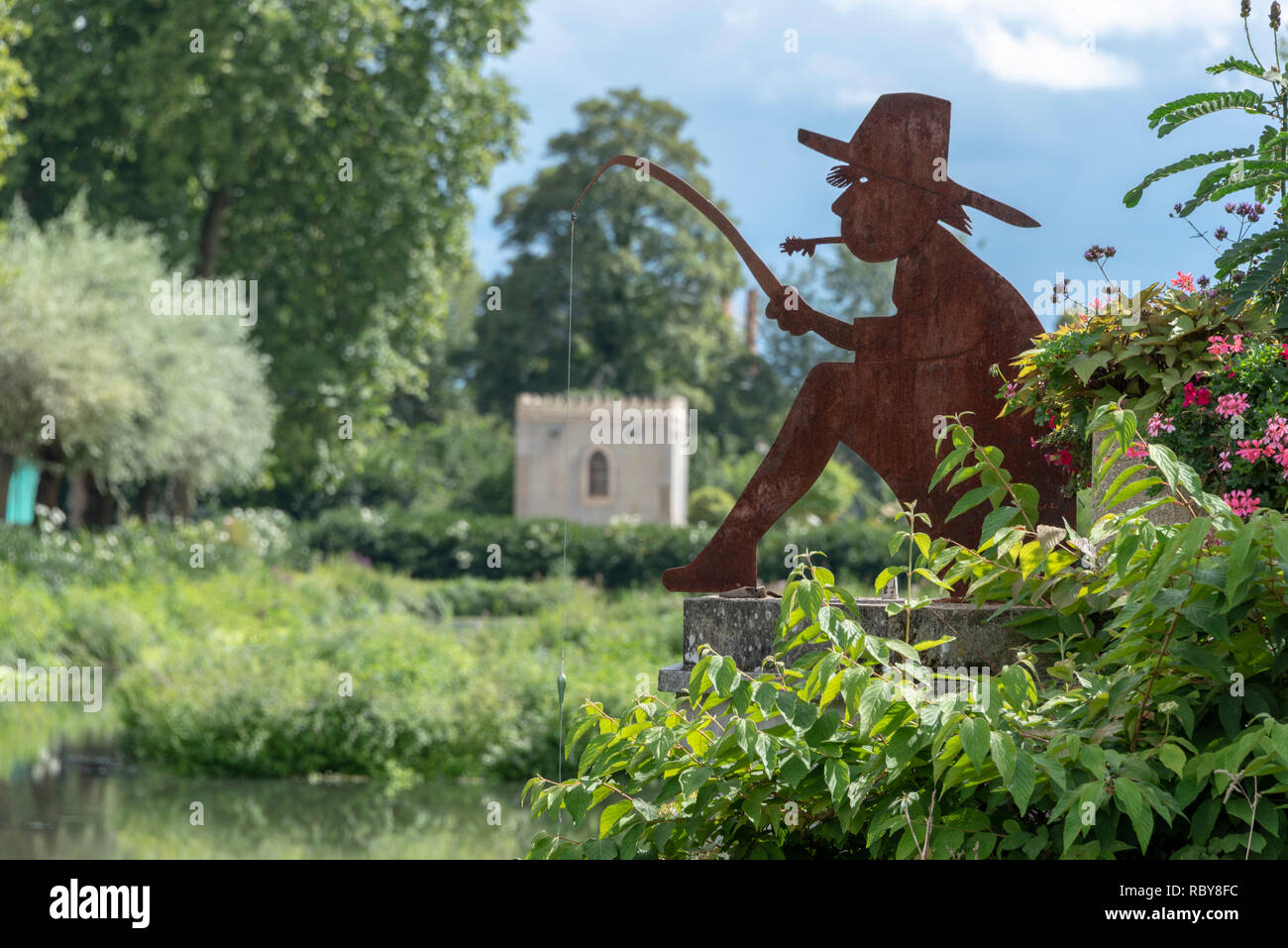 A rusting fisherman statue on the banks of the Loire river at La Flèche ...