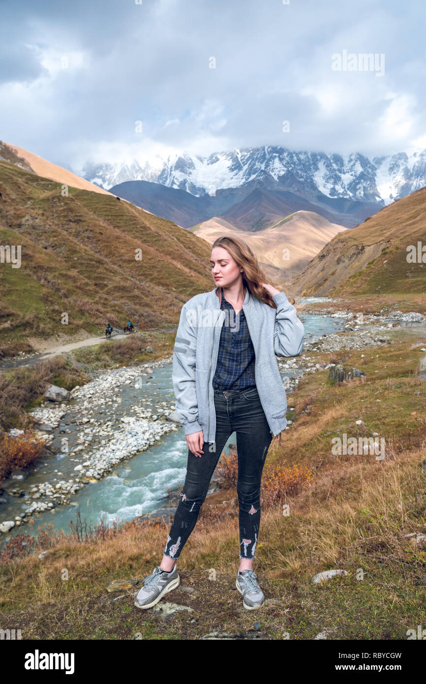 Beautiful girl on a mountain background of Svaneti, mountain Shkhara ...