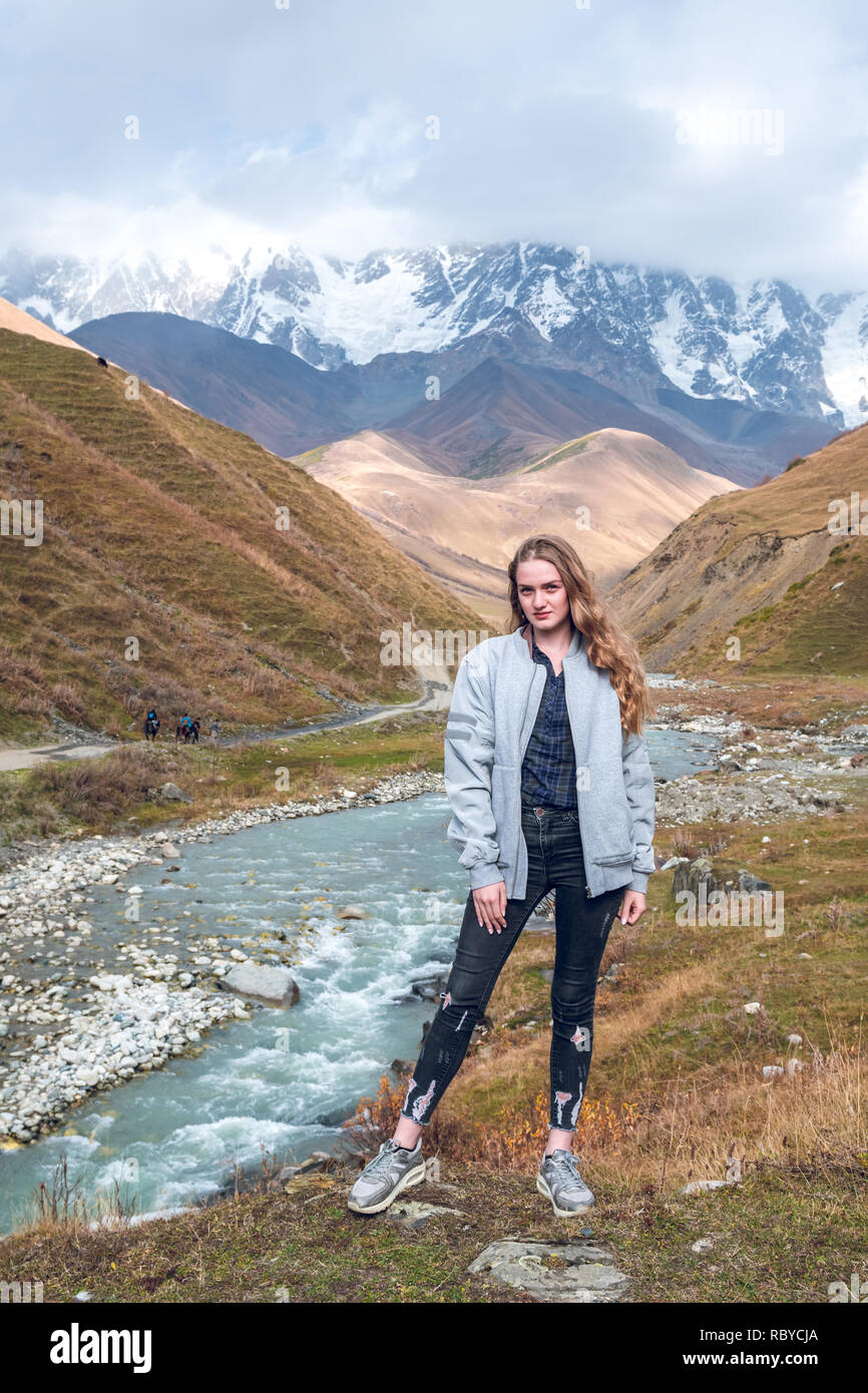 Beautiful girl on a mountain background of Svaneti, mountain Shkhara ...