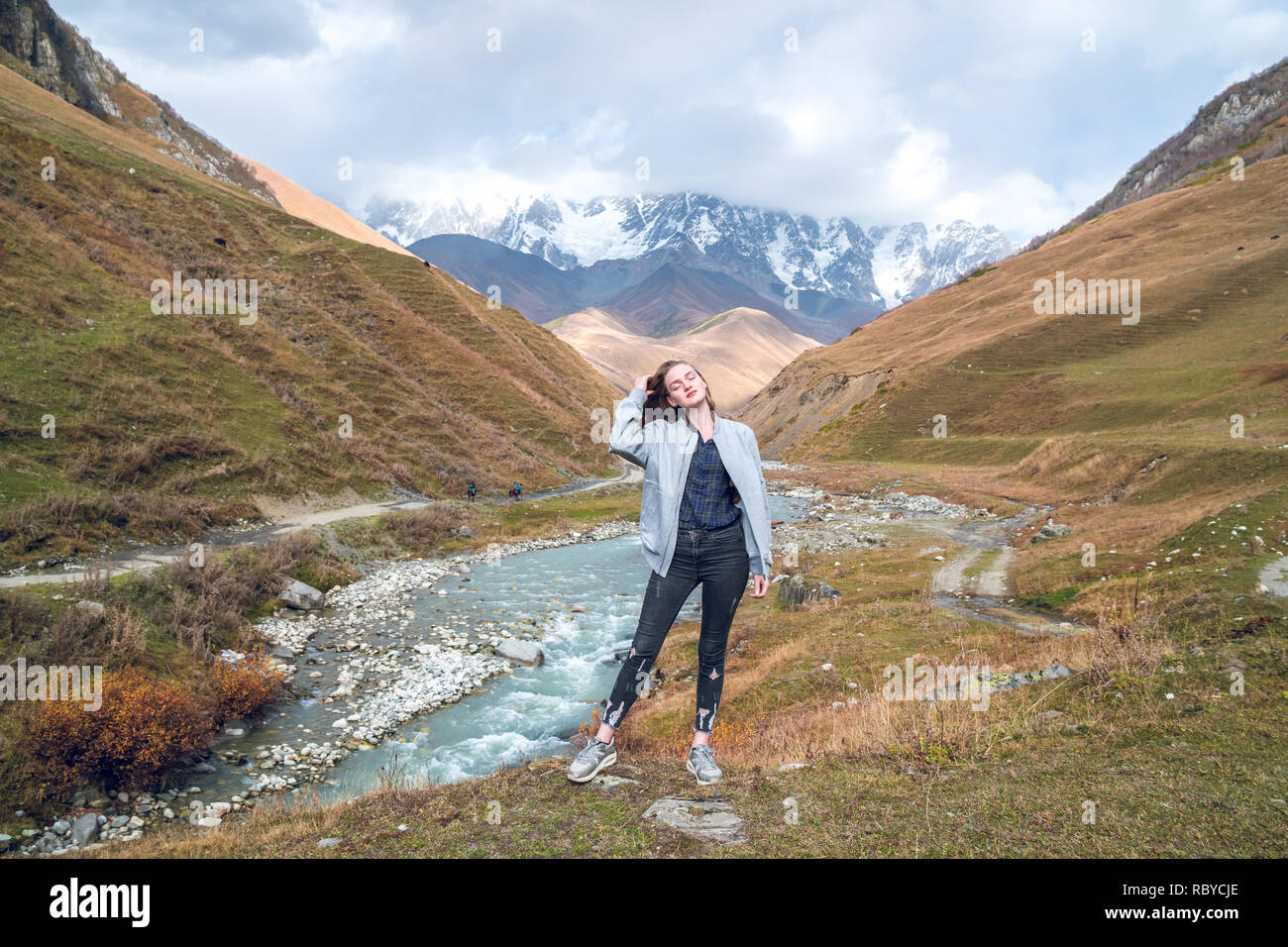 Beautiful girl on a mountain background of Svaneti, mountain Shkhara ...