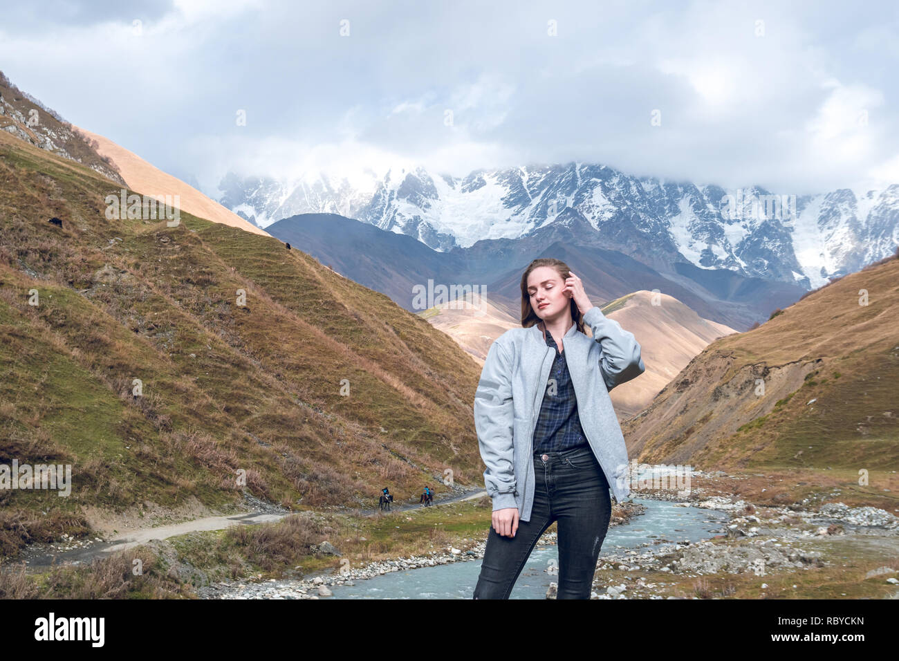 Beautiful girl on a mountain background of Svaneti, mountain Shkhara ...