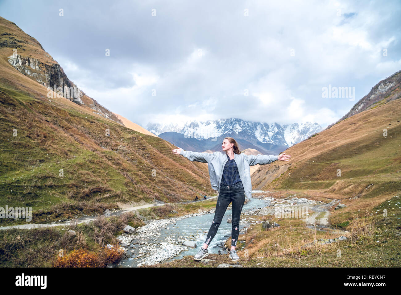 Beautiful girl on a mountain background of Svaneti, mountain Shkhara ...