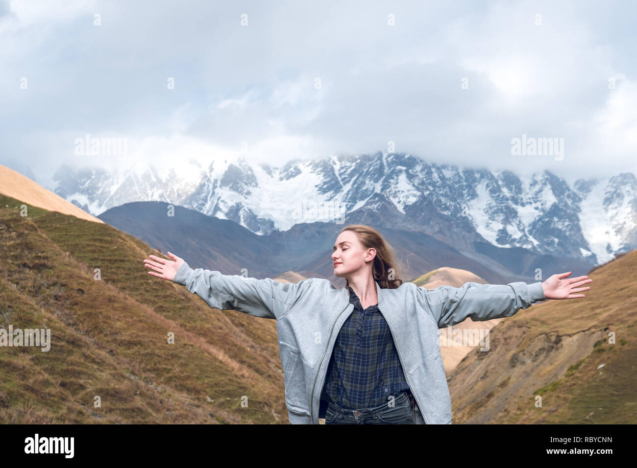 Beautiful girl on a mountain background of Svaneti, mountain Shkhara ...