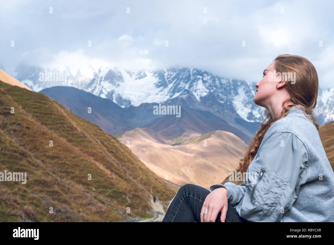 Beautiful girl on a mountain background of Svaneti, mountain Shkhara ...