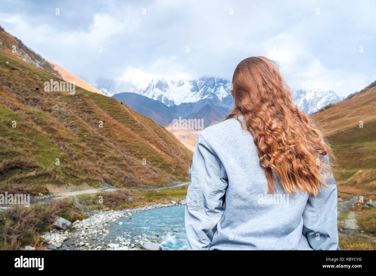 Beautiful girl on a mountain background of Svaneti, mountain Shkhara ...