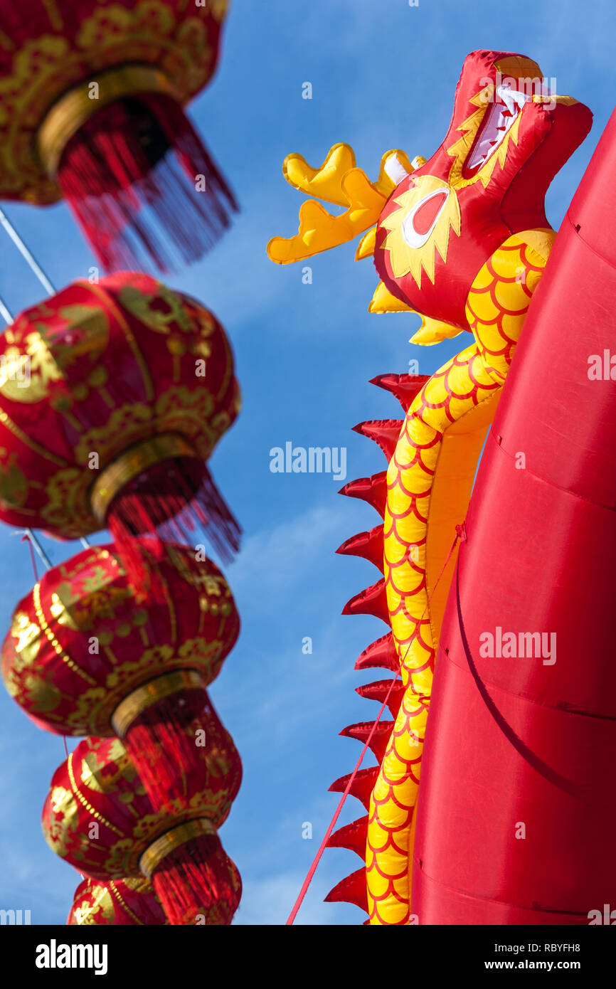 Inflatable chinese dragon and lanterns against blue sky Stock Photo - Alamy