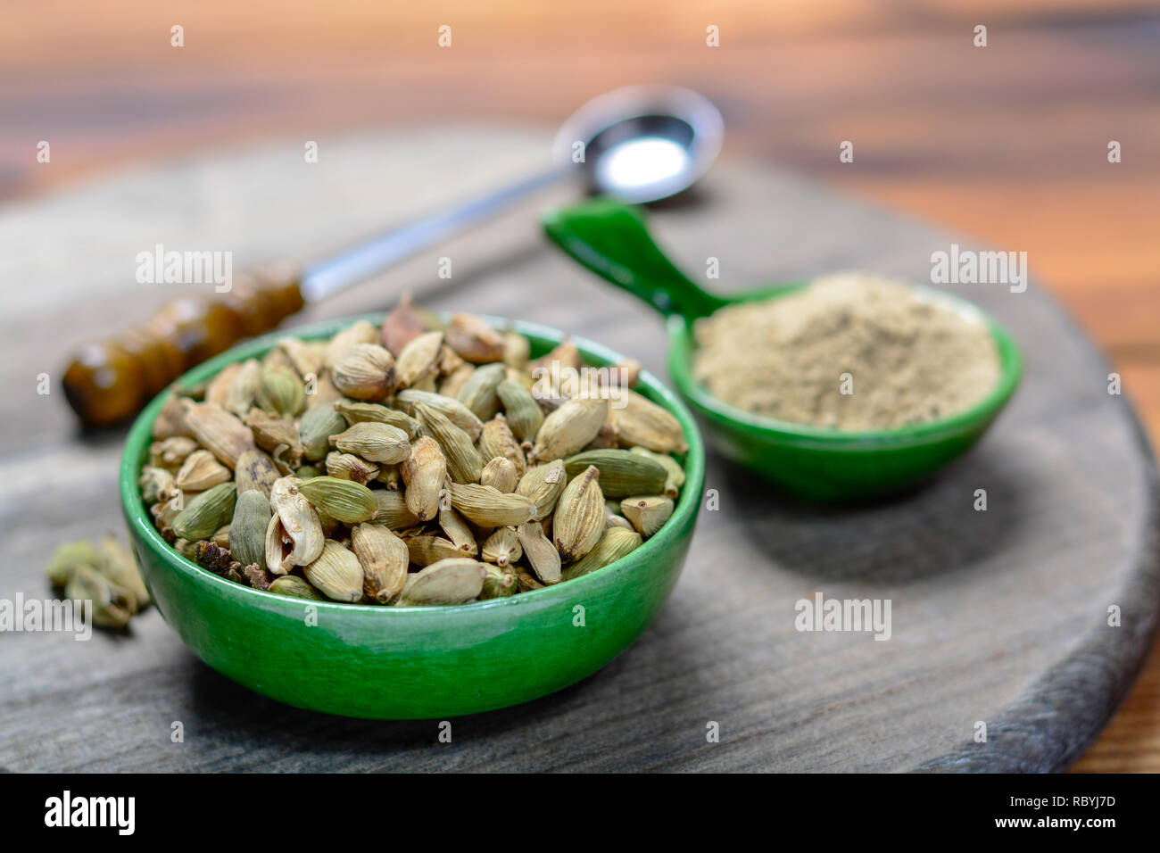 Bowl with cardamom pots and cardamom powder, used for cooking and ...