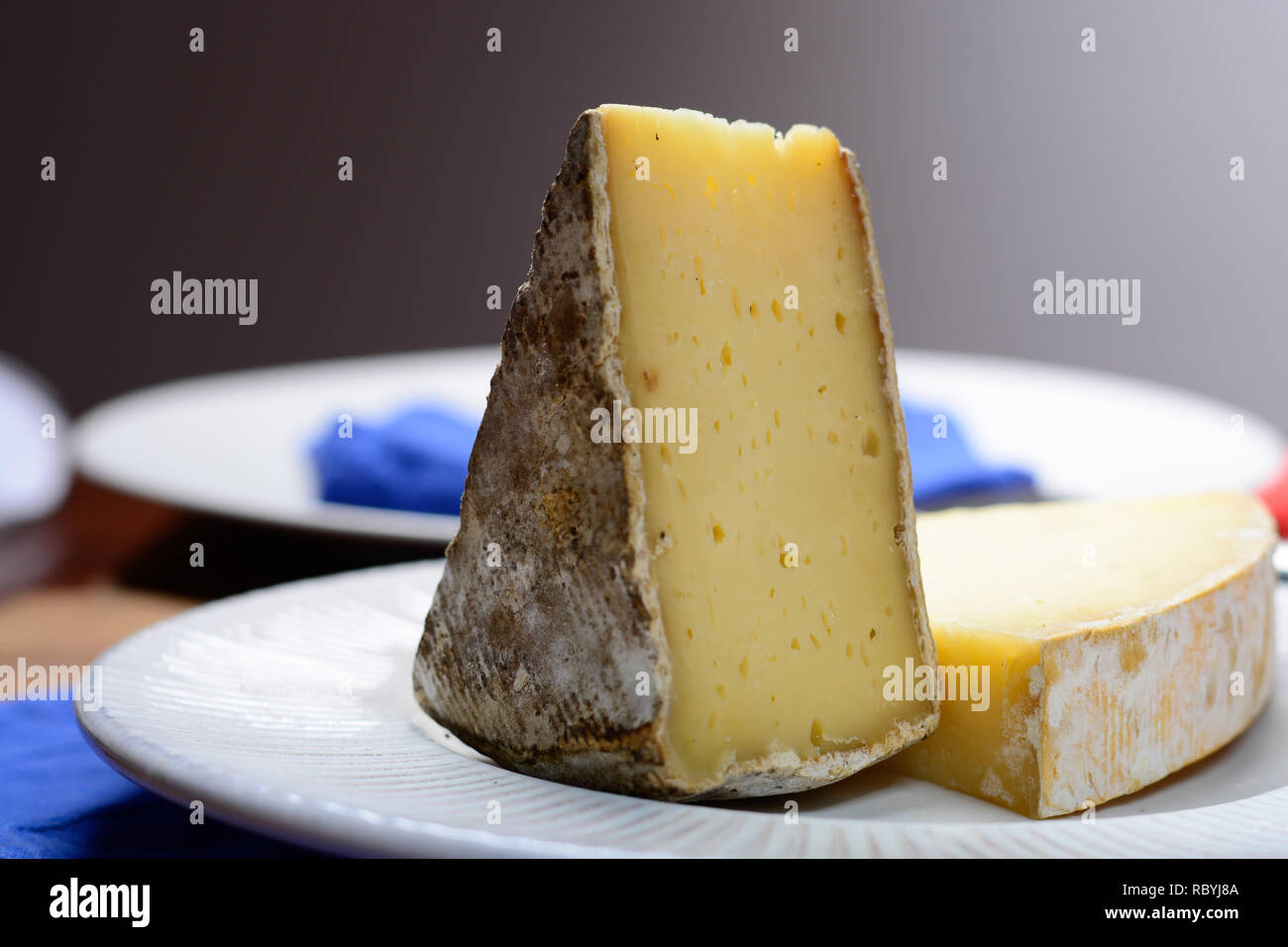 Pieces of French Tomme and Cantal cheese, close-up Stock Photo - Alamy