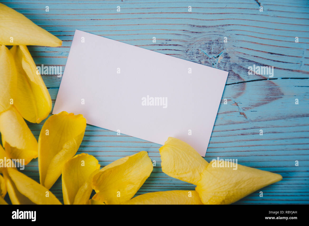 Visiting card in rose petals on rustic wooden background romantic ...