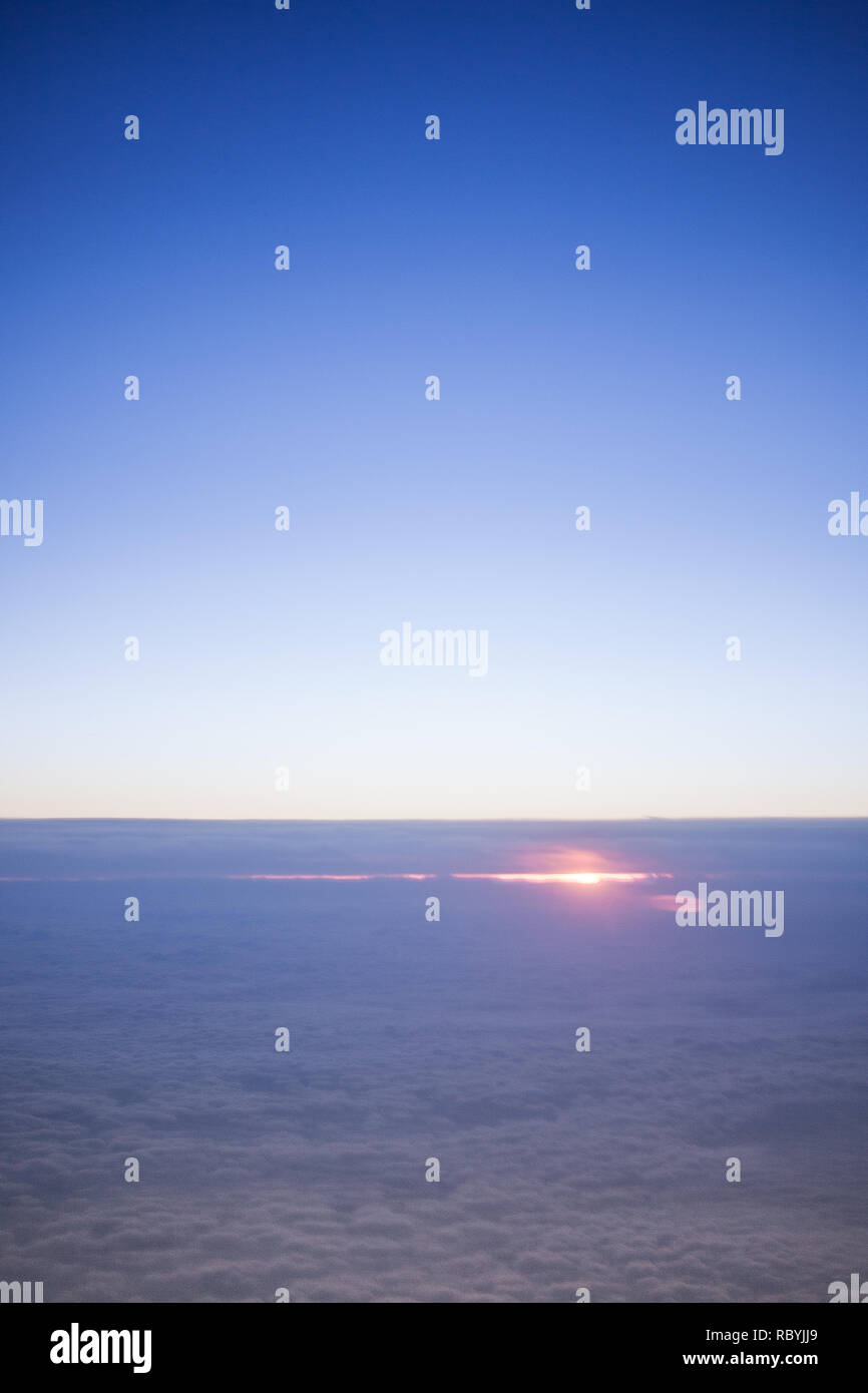 Sunrising through clouds, view from airplane over France Stock Photo ...