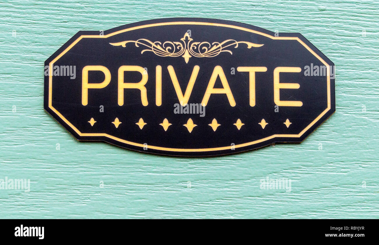 ornate yellow and brown sign saying PRIVATE on an aqua exterior wall ...