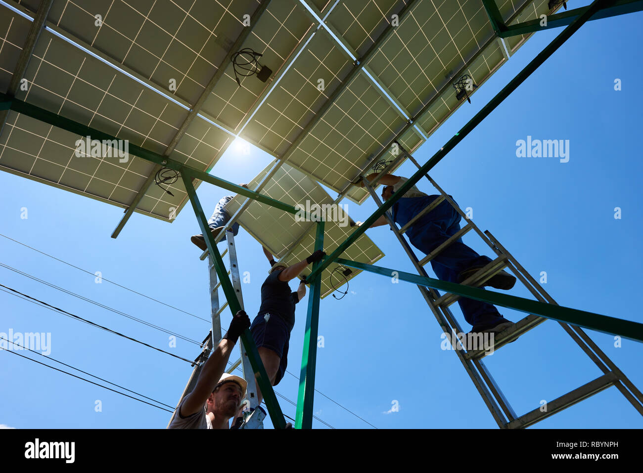 Mounters team installing solar batteries on house's roof. Innovative ...