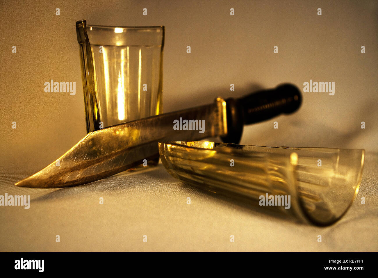 The glass is cut with a knife into two parts. Attention! The image ...