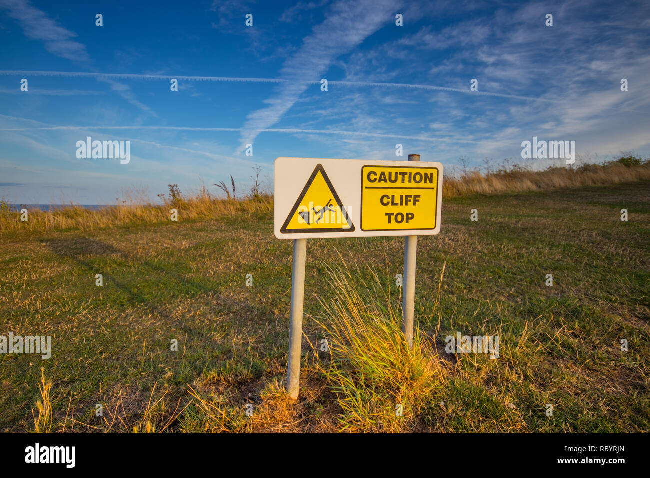 Cliff top warning signs above Durlston Bay, Swanage, Dorset, UK Stock ...