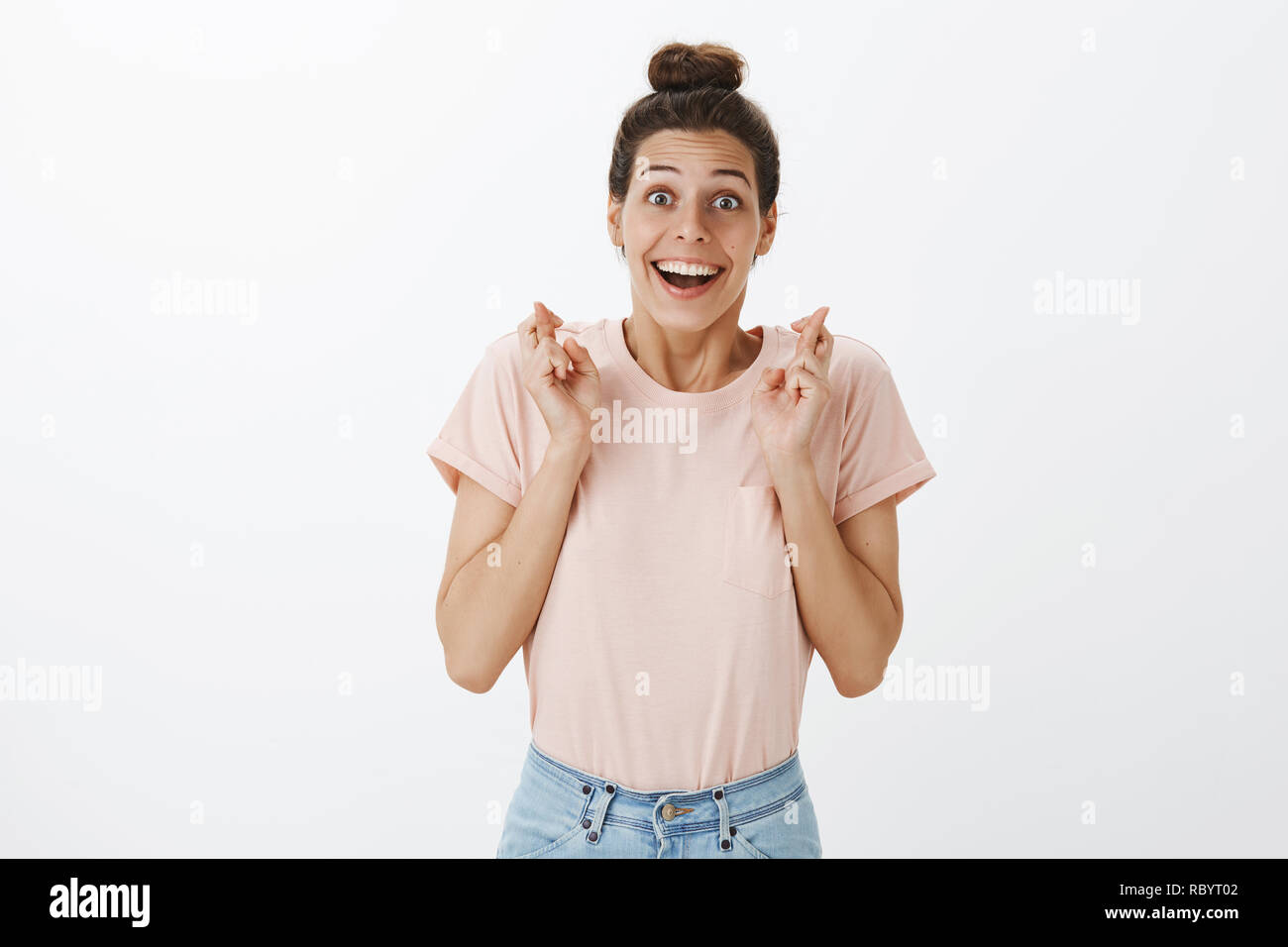 Optimistic and joyful young attractive woman feeling happy and relieved ...