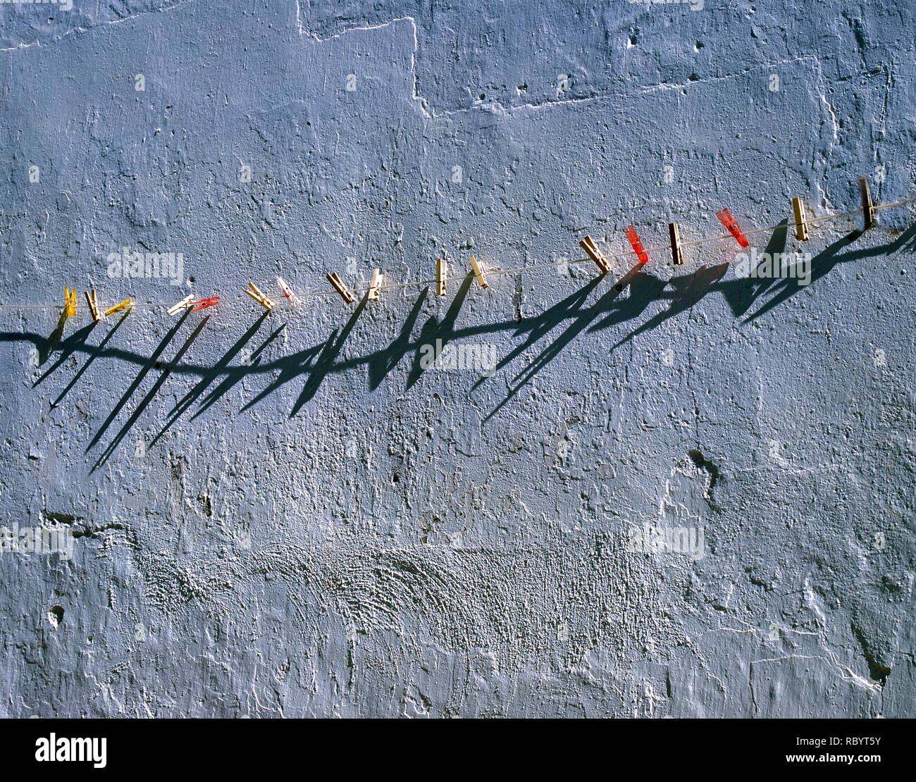 a rope washing line running across the centre with red and yellow ...
