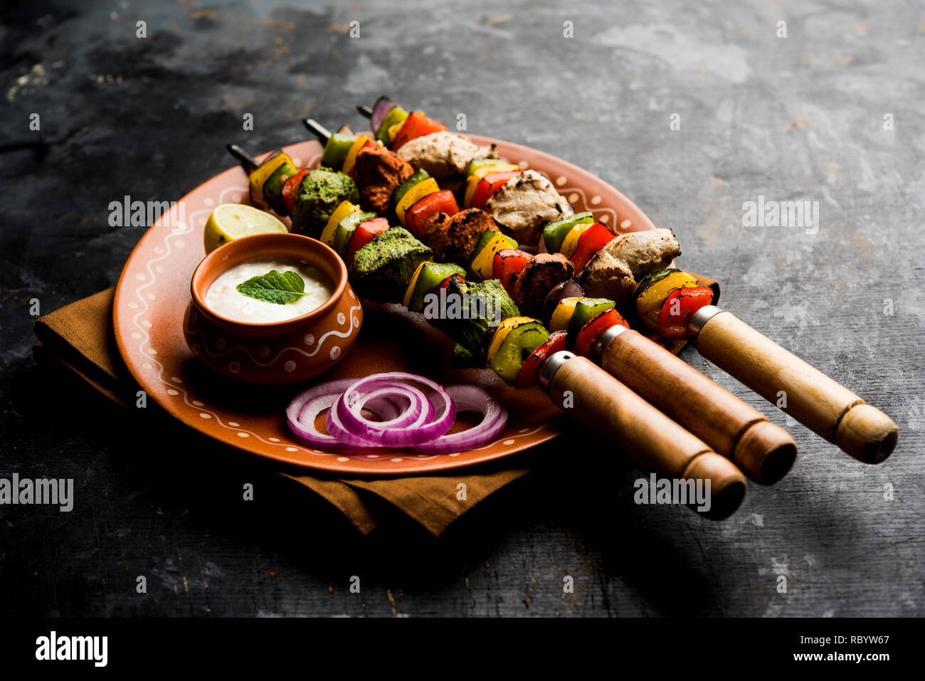 Chicken Hariyali kakab or Malai malai kebab served with skewers and ...