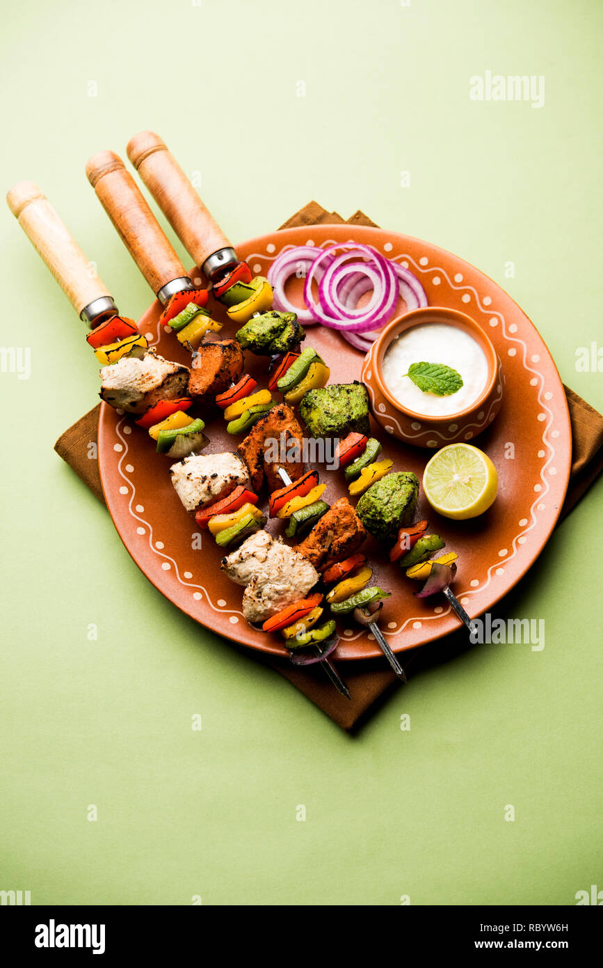 Chicken Hariyali kakab or Malai malai kebab served with skewers and ...