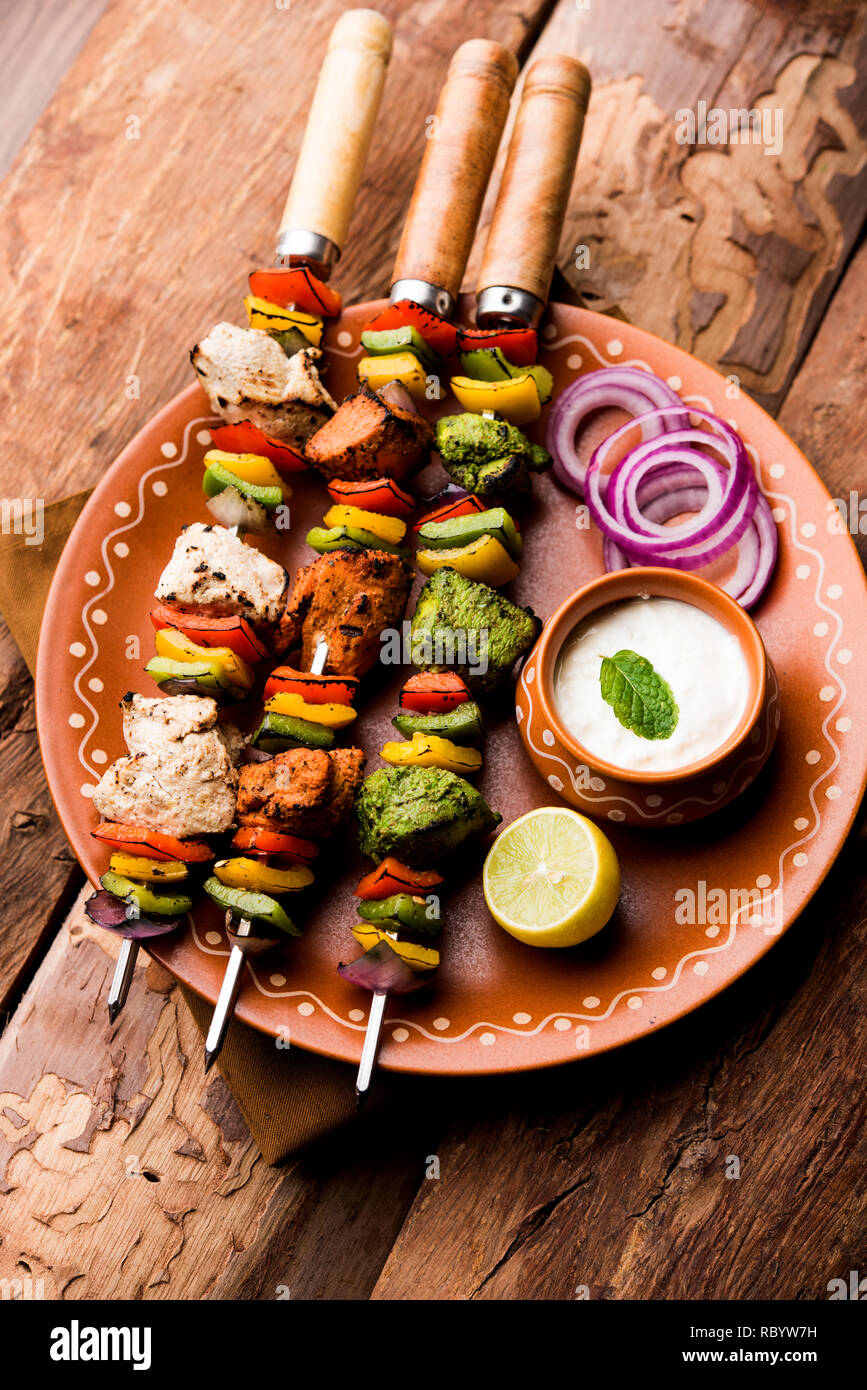 Chicken Hariyali kakab or Malai malai kebab served with skewers and ...