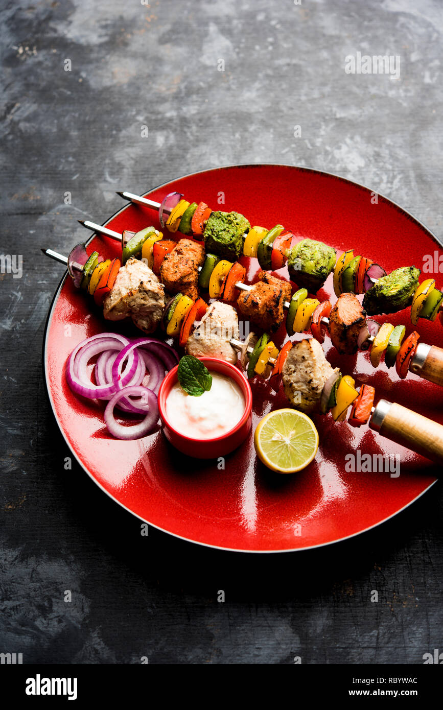 Chicken Hariyali kakab or Malai malai kebab served with skewers and ...