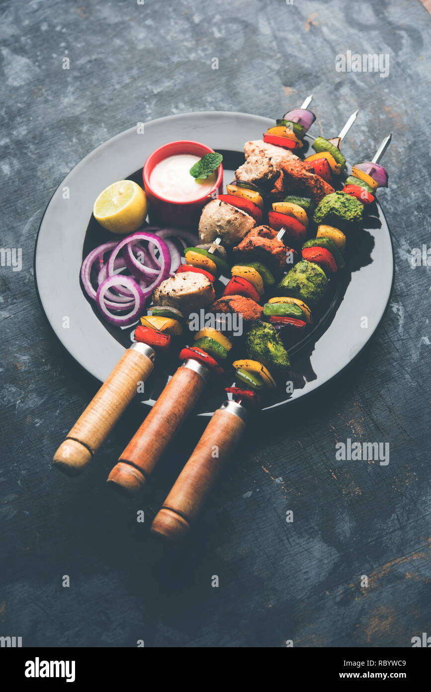 Chicken Hariyali kakab or Malai malai kebab served with skewers and ...
