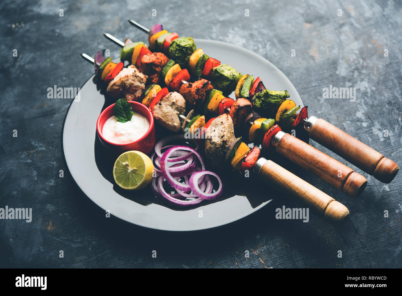 Chicken Hariyali kakab or Malai malai kebab served with skewers and ...