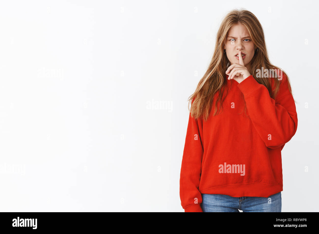 Intense displeased serious-looking attractive girl with long hair ...