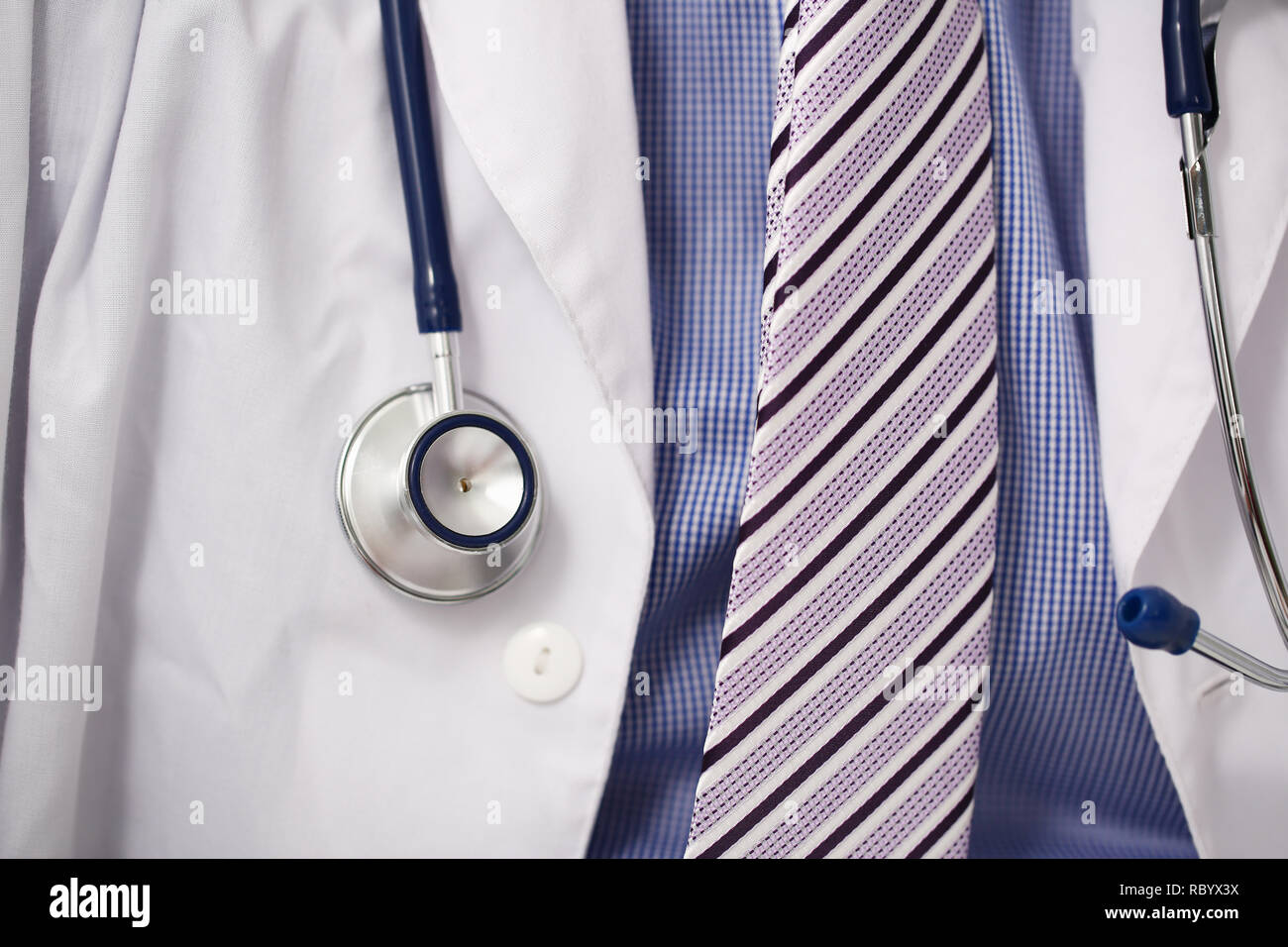 Stethoscope lying on male therapeutist doctor chest Stock Photo - Alamy