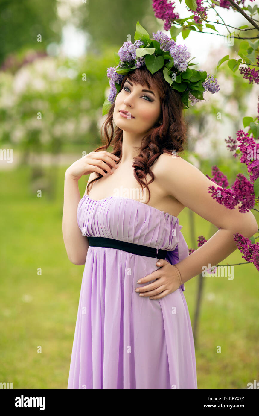 beautiful girl in purple dress with lilac flowers Stock Photo - Alamy