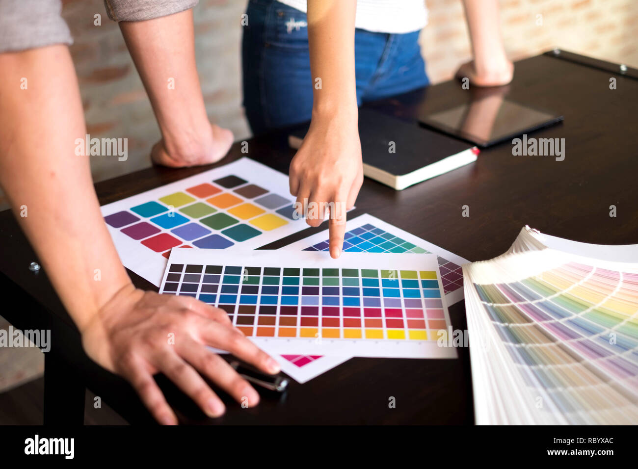 Graphic designers choose colors from the color bands samples for design ...