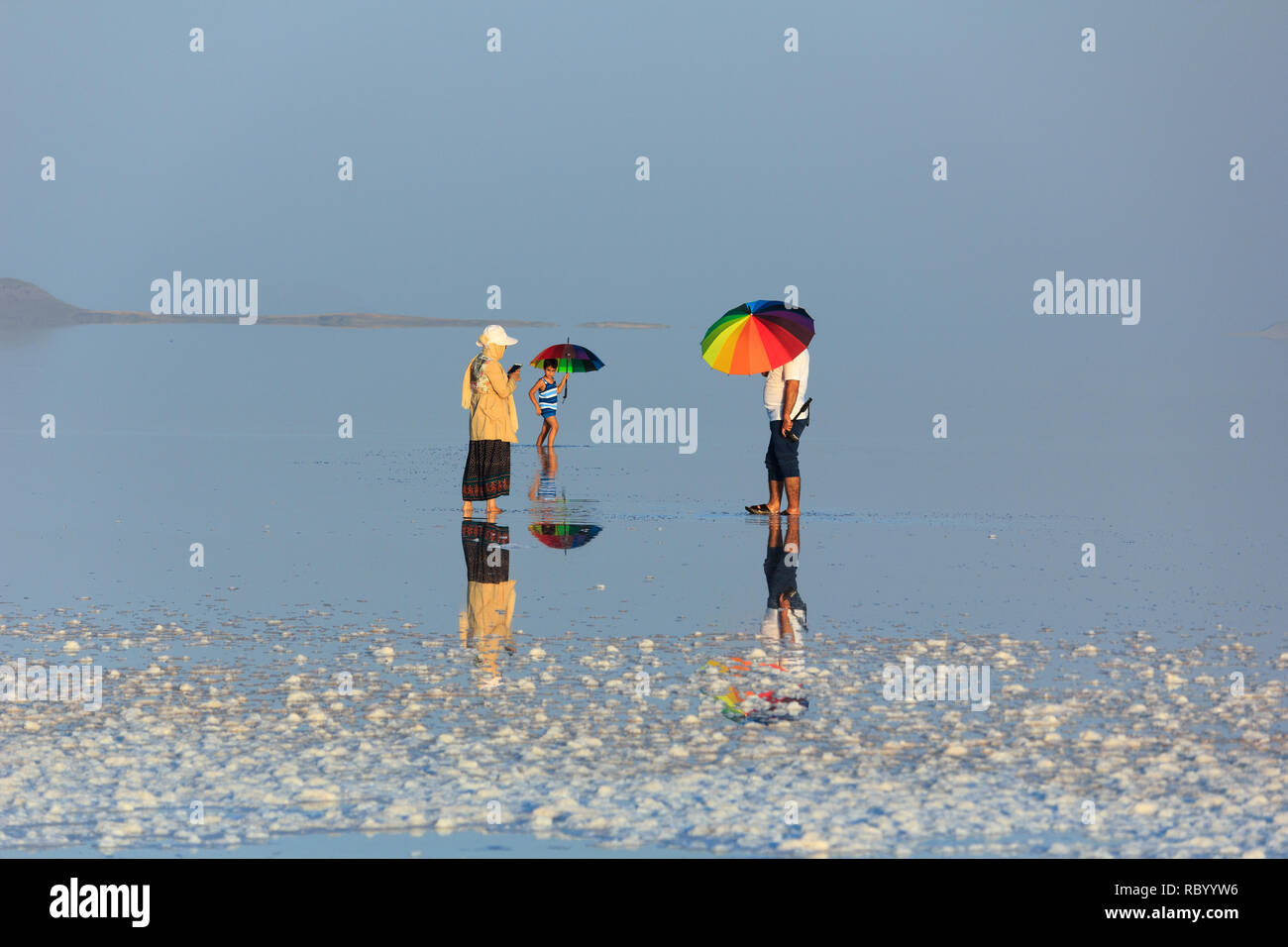 A family on the salt flat of Urmia Lake, West Azerbaijan province, Iran ...