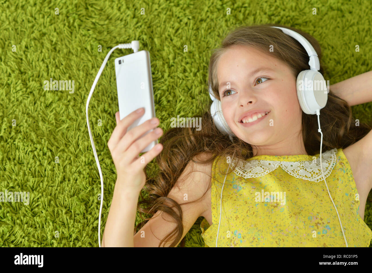 Portrait of cute little girl with headphones Stock Photo - Alamy
