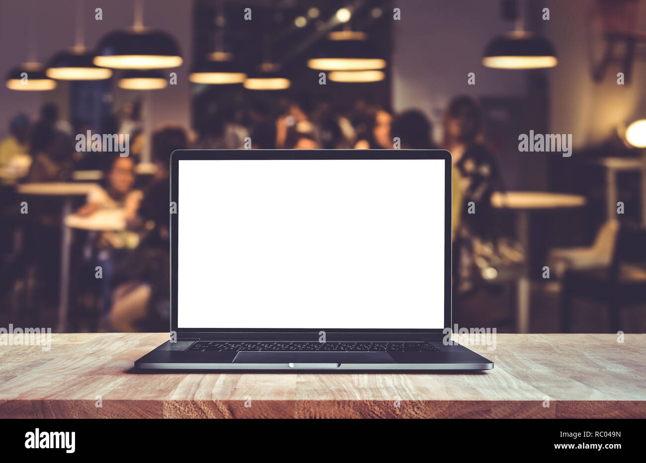 Modern computer,laptop on counter bar with blur cafe,restaurant ...