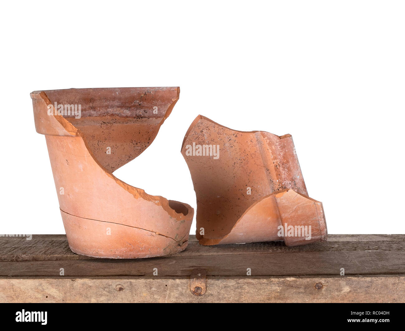 A broken terracotta flowerpot on old box, isolated on white bhind ...
