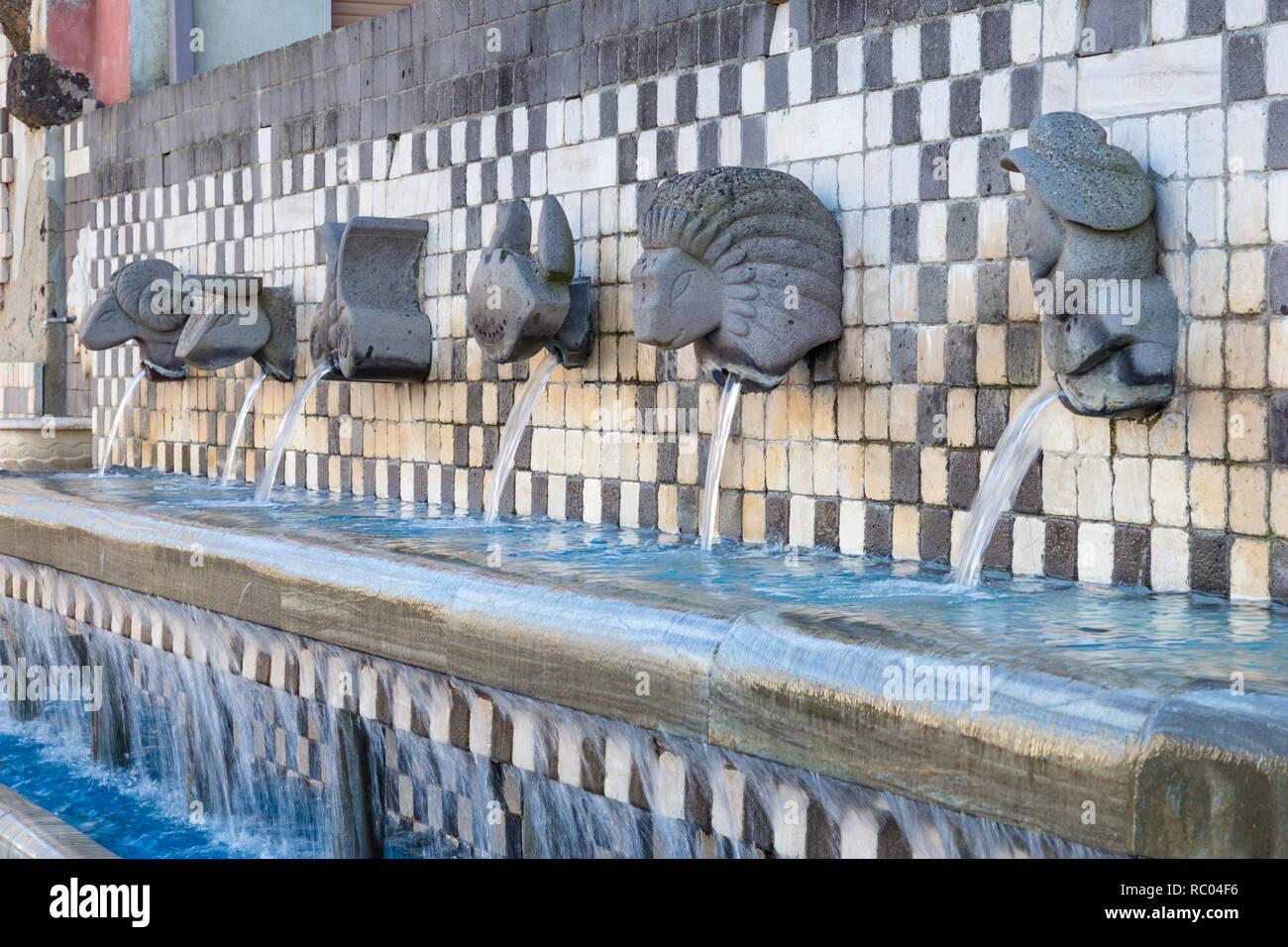 Ancient Italian water fountain with sculptures of spitting animal heads ...