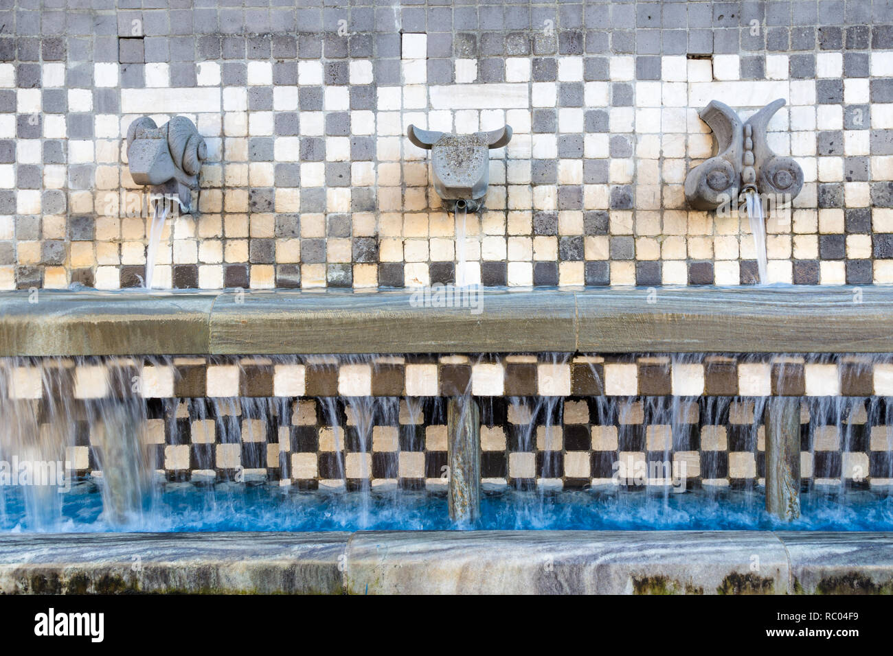 Ancient Italian water fountain with sculptures of spitting animal heads ...