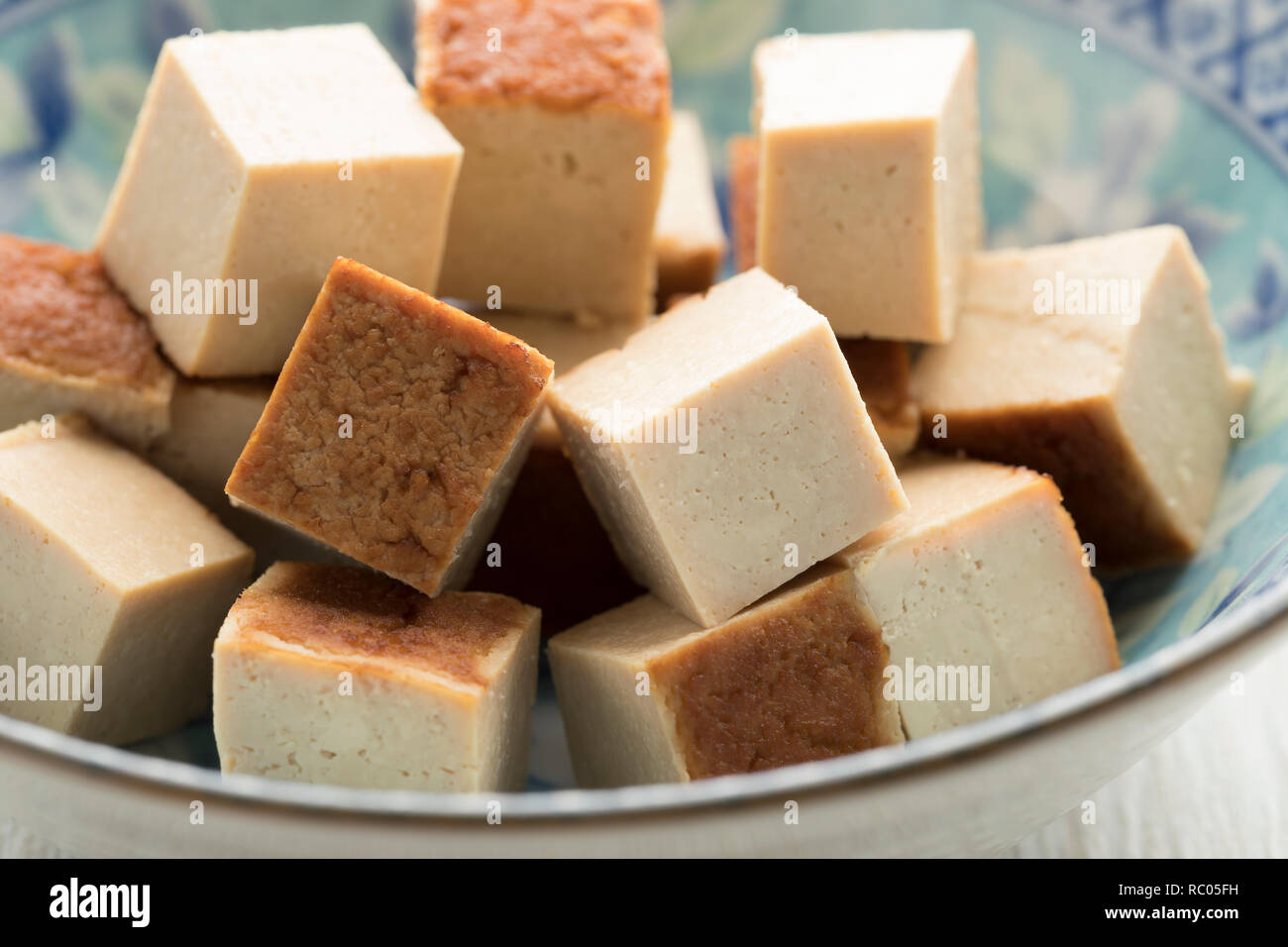 Cubes of smoked tofu on a dish close up Stock Photo - Alamy