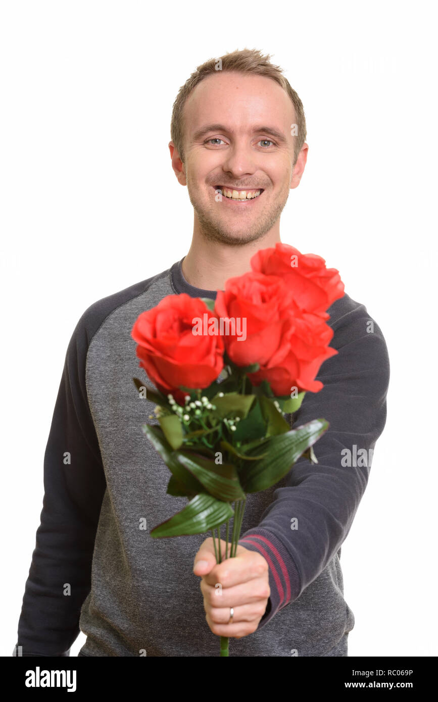 Happy handsome Caucasian man giving red roses ready for Valentin Stock ...
