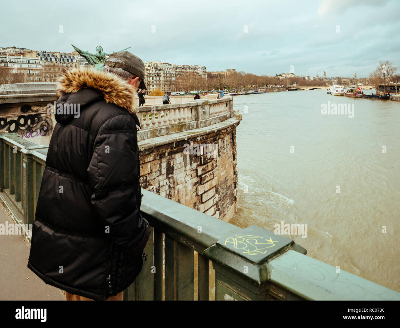 PARIS, FRANCE - JAN 30, 2018: Parisian senior man watch the swollen ...