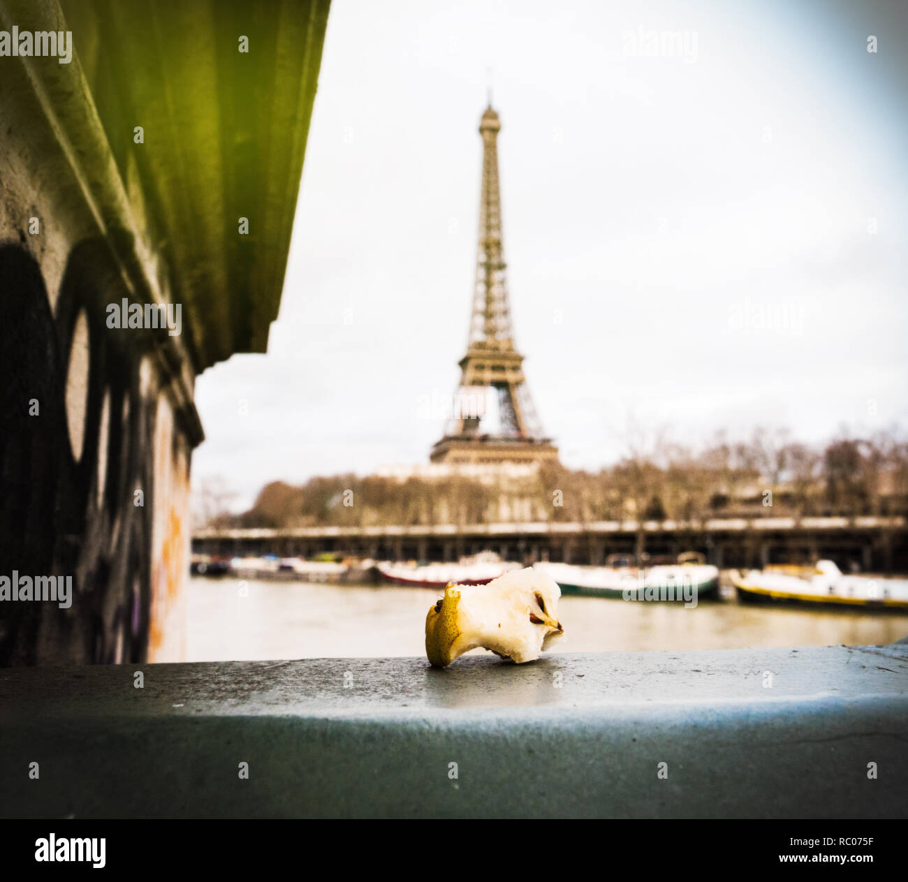 Bitten apple core left on Paris bridge with eiffel Tower in the ...