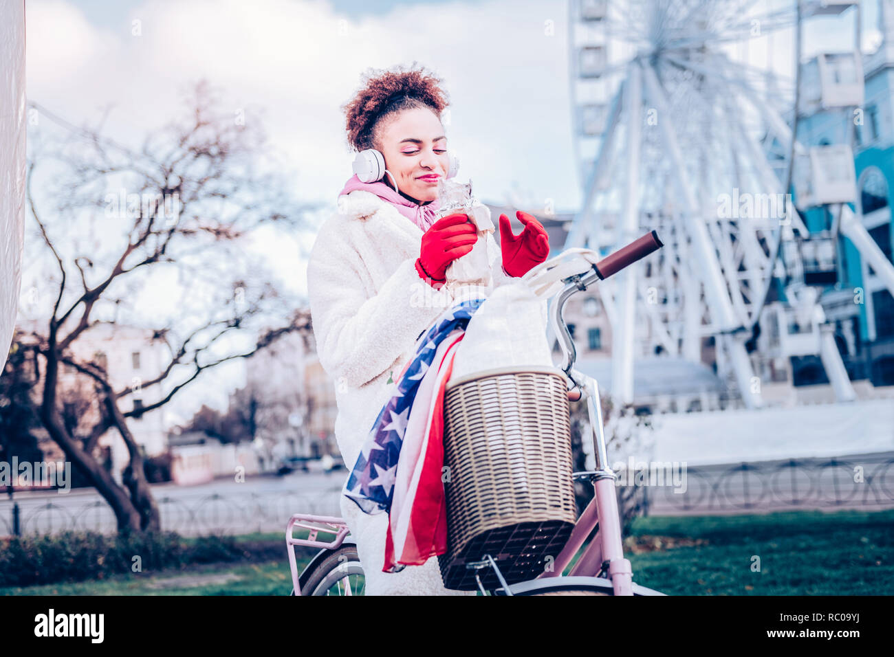Positive delighted girl sitting on her bicycle Stock Photo - Alamy