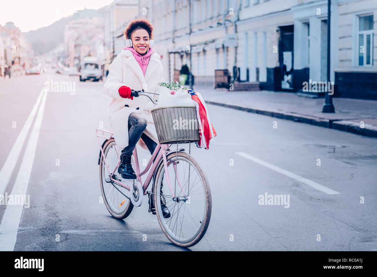 Positive delighted female person riding her bicycle Stock Photo - Alamy